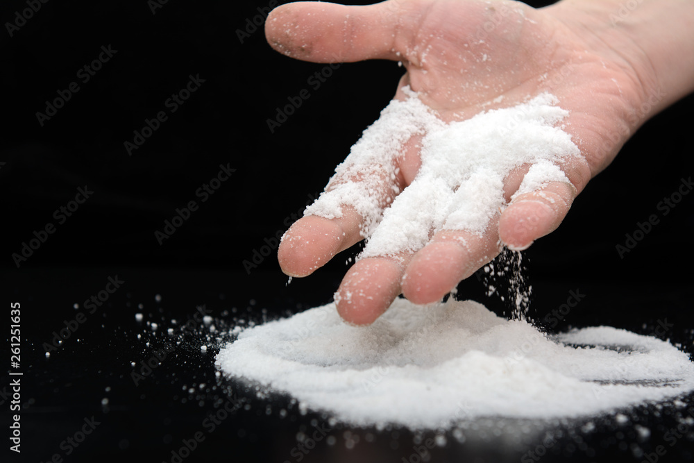 On the palm of a young man a pinch of salt, which he pours down. Image ...