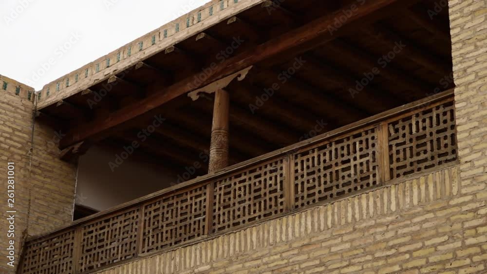 A close-up, still, shot of a balcony with wooden railings and ...