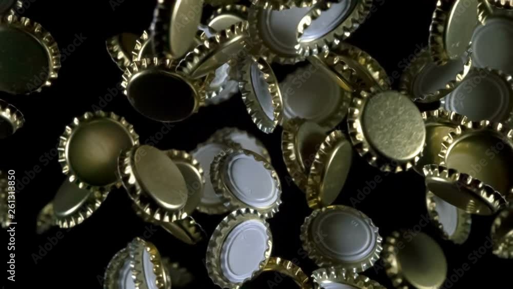Vidéo Stock Beer Bottle Caps. Golden beer bottle caps floating in the ...
