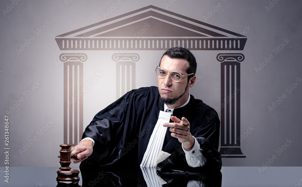 Young judge in front of a courthouse symbol making decision Stock Photo ...