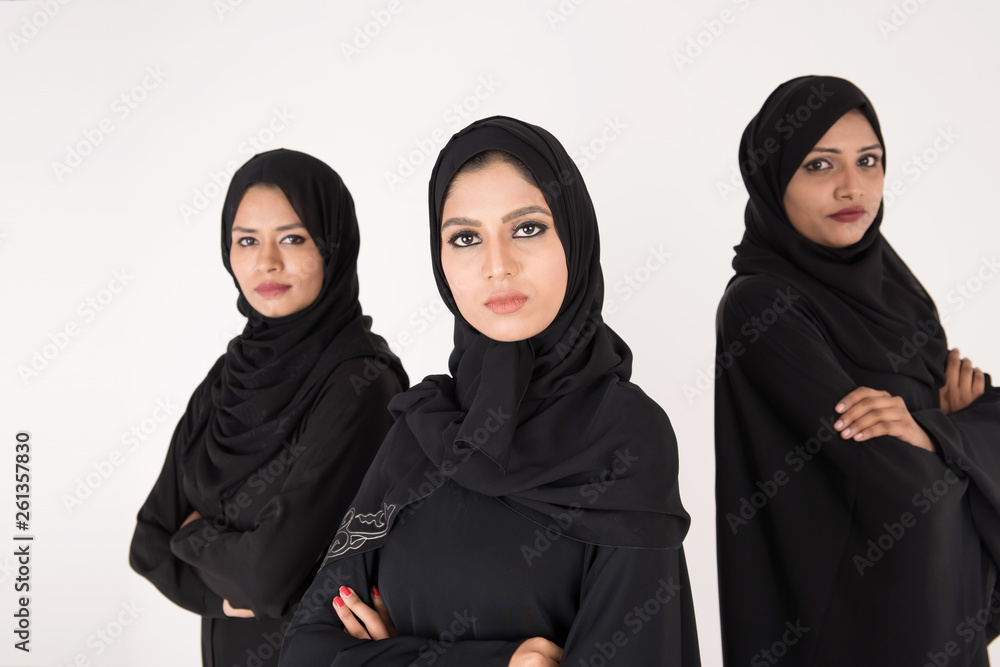 Arab women in traditional dress standing on white background Stock ...