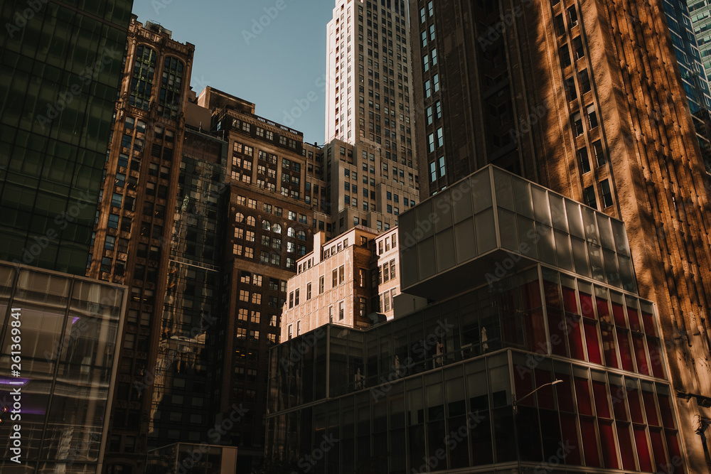 From below of exterior of buildings in density on street of New York ...