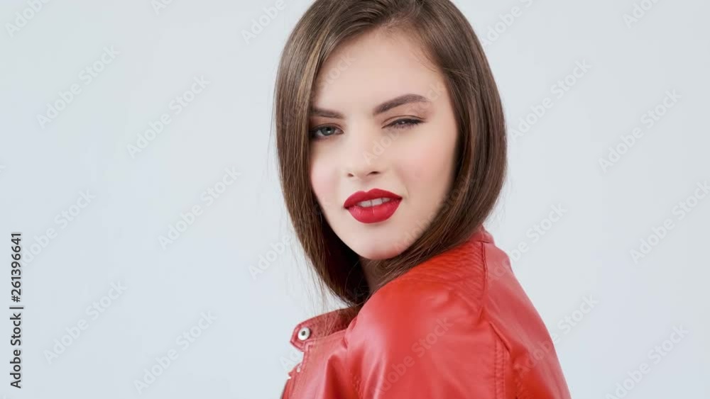 Beautiful girl turns around and winks. Portrait of a beautiful young ...