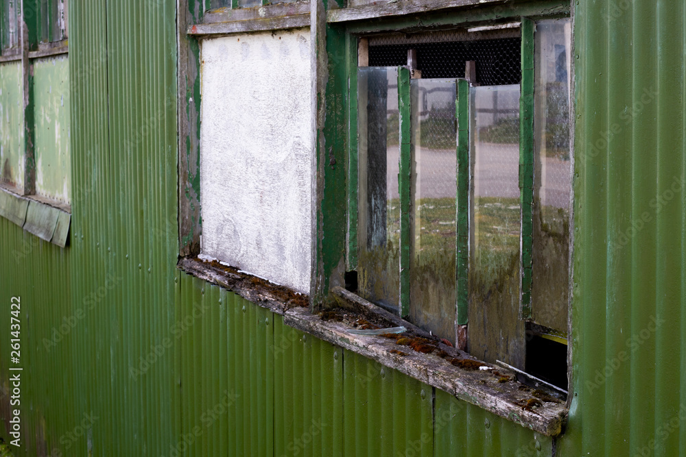Dilapidated wooden window frame on condemned derelict factory building ...