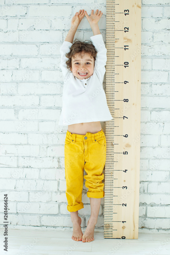 Child measures height Stock Photo | Adobe Stock