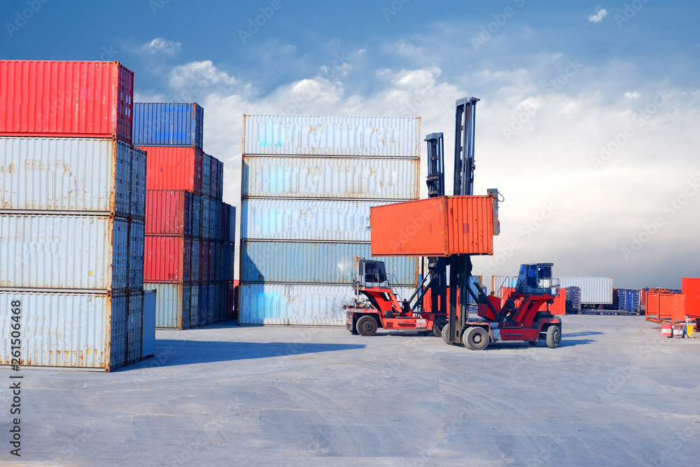 Forklift truck lifting cargo container in shipping yard or dock yard ...