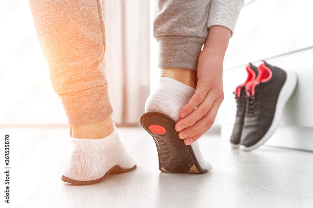 Sports woman fitting orthopedic insoles. Treatment and prevention of ...
