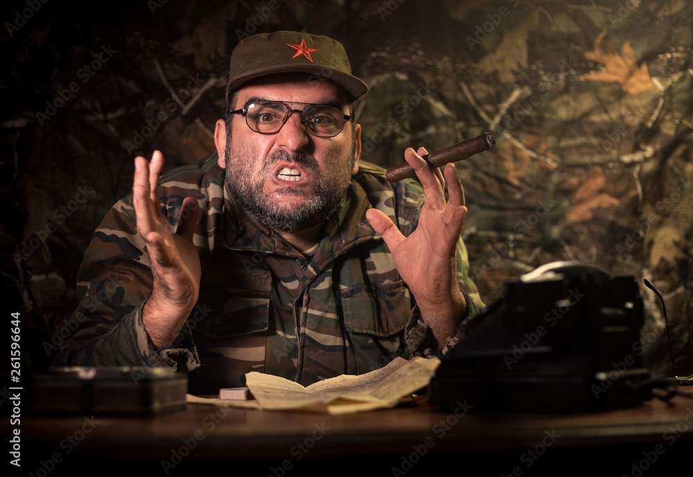 The evil dictator sitting on table. Angry communist general sitting at ...
