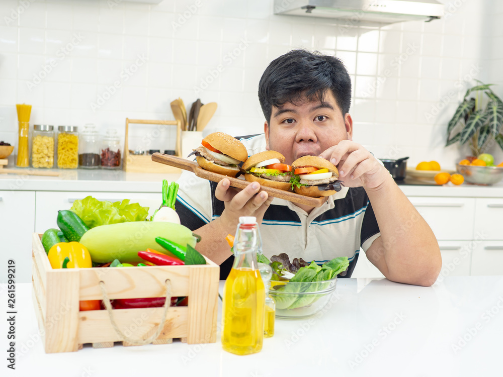young Asia fat man happy when he eating unhealthy food or junk food ...