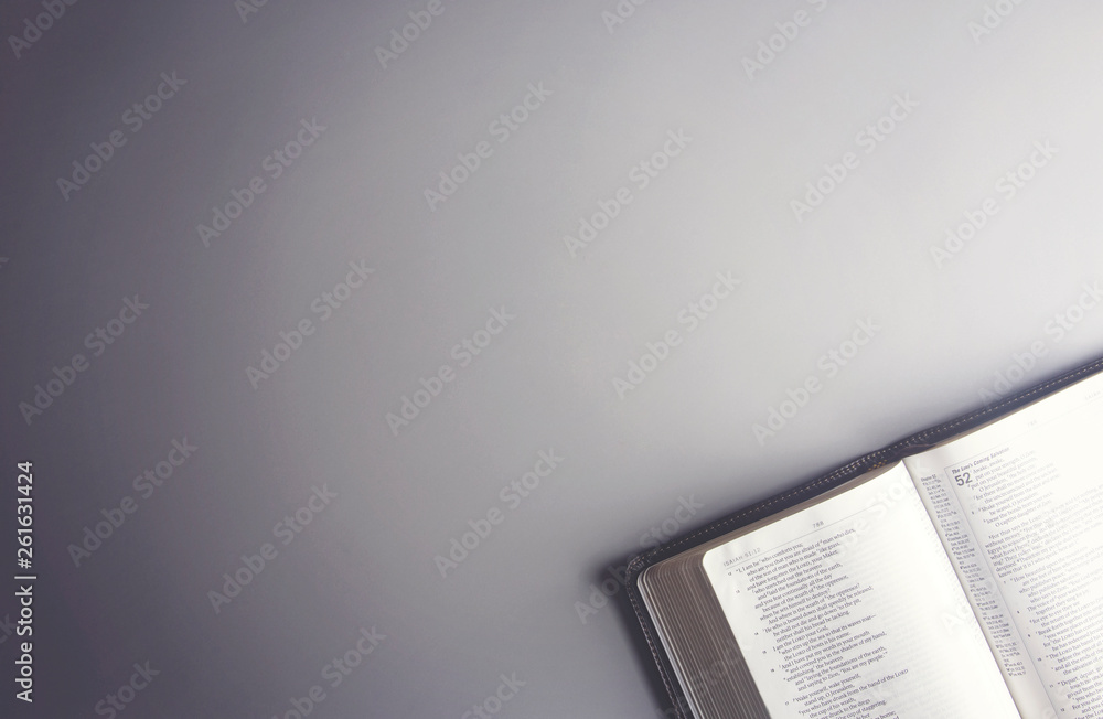 Single Bible Open on a Gray Background Stock Photo | Adobe Stock