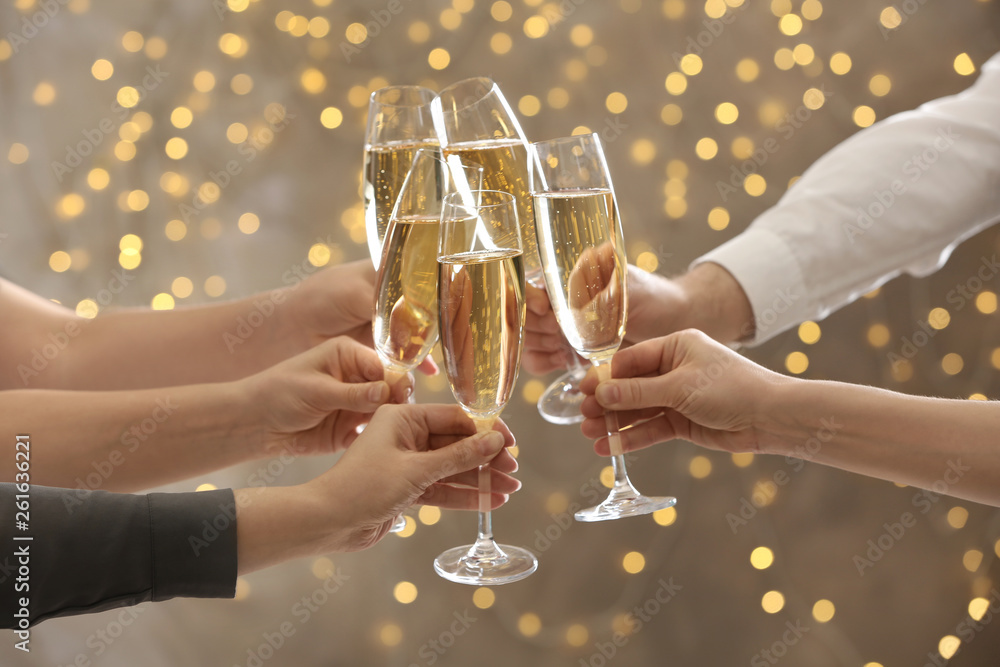 People clinking glasses of champagne on blurred background, closeup ...