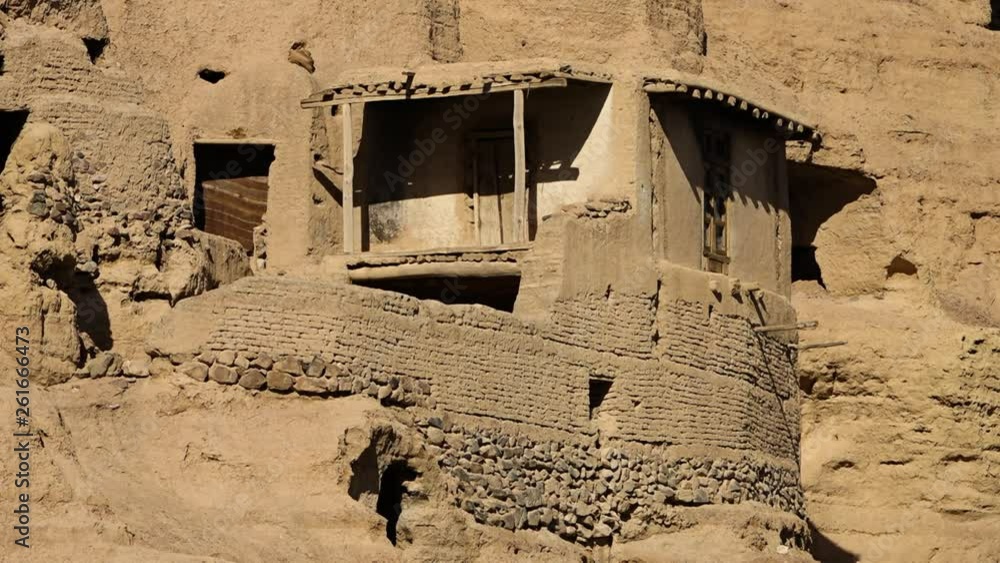 Mountain house. Window opening with roof jutting out from rock cliff ...