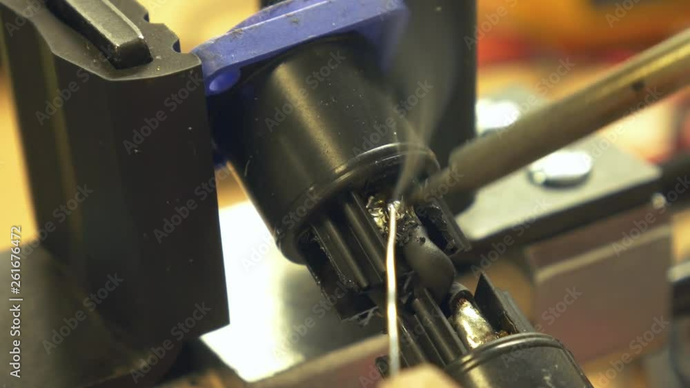 Electronics engineer soldering cable from the audio jack connector ...