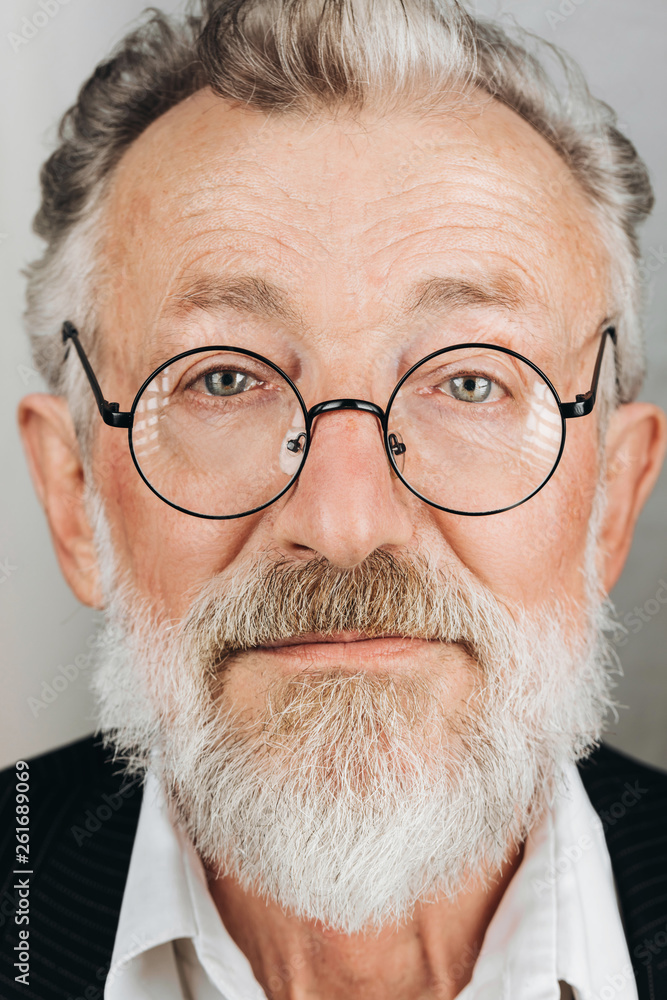 Old man portrait. Caucasian elderly man in round eyewear looking at ...