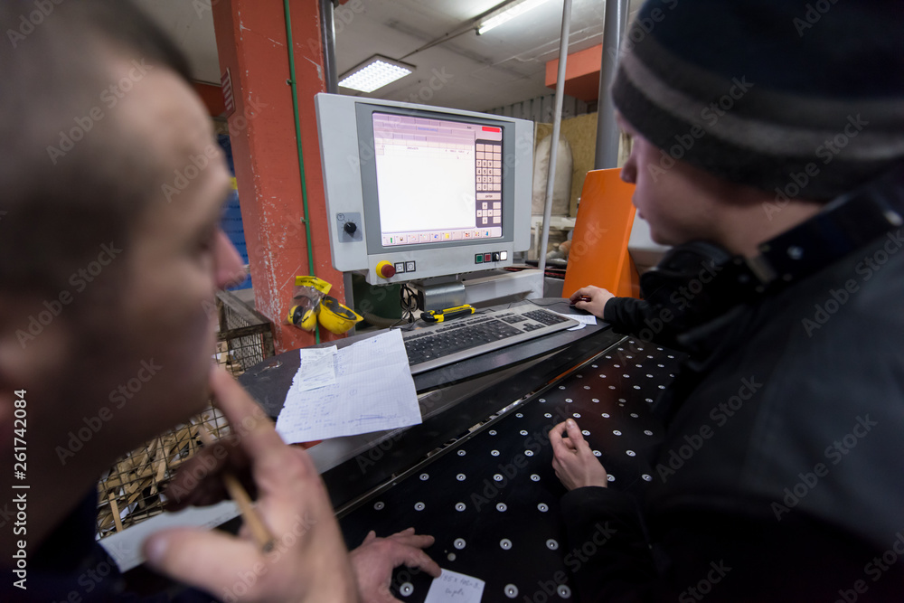 carpenters calculating and programming a cnc wood working machine Stock ...