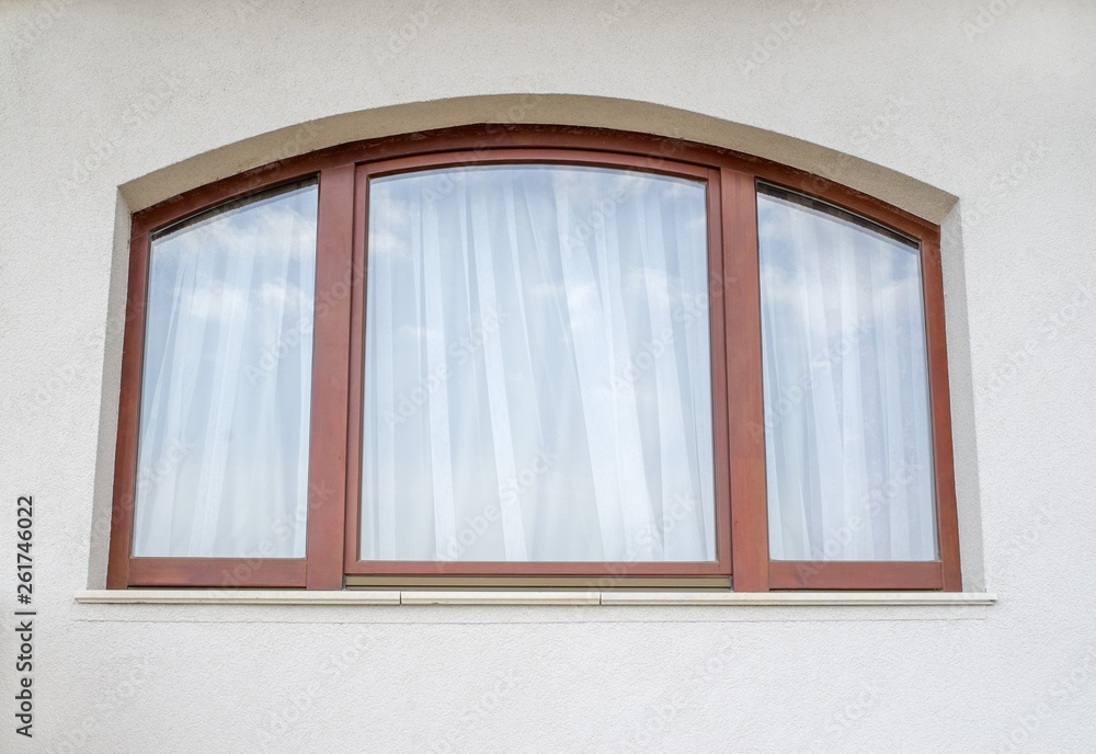 New wooden arched triple window with thin seamless curtain Stock Photo ...