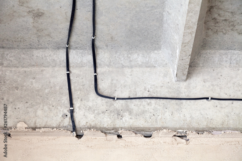 Cable laying the ceiling. Electrical wires on wall. Wiring replacement ...
