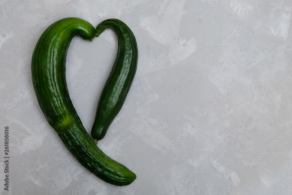 Trendy organic cucumbers shaped in a form of heart. Image with copy ...