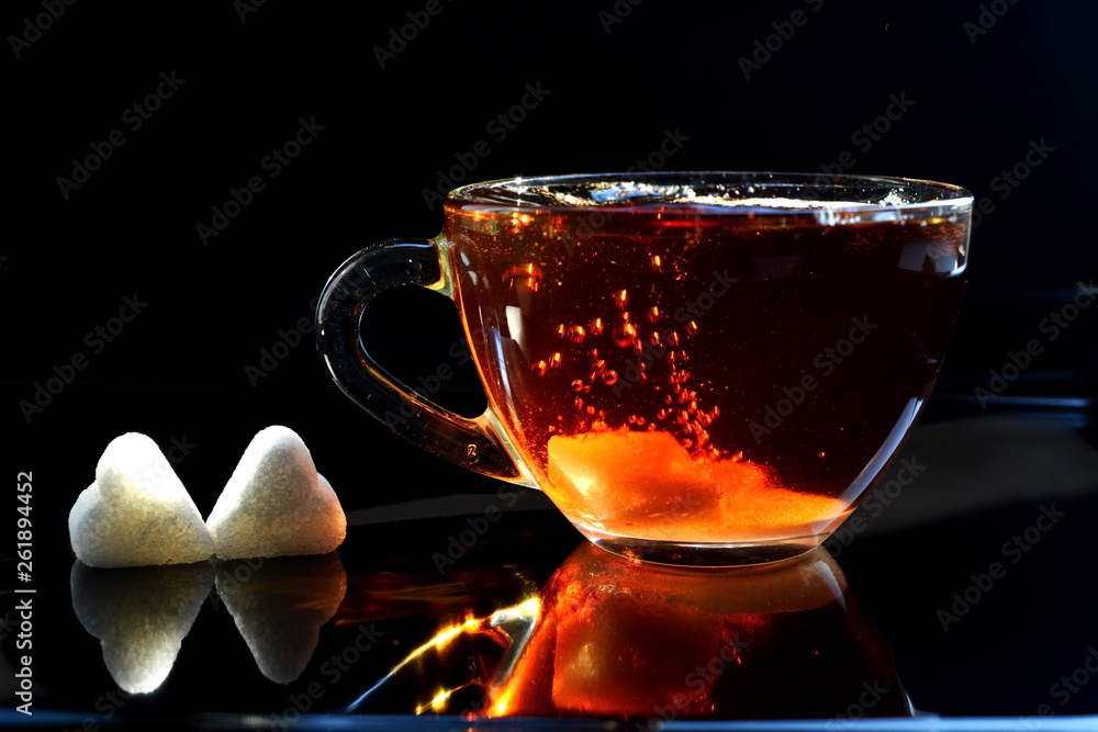 Glass Cup of brown black hot sweet tea with bubbles and splash from ...
