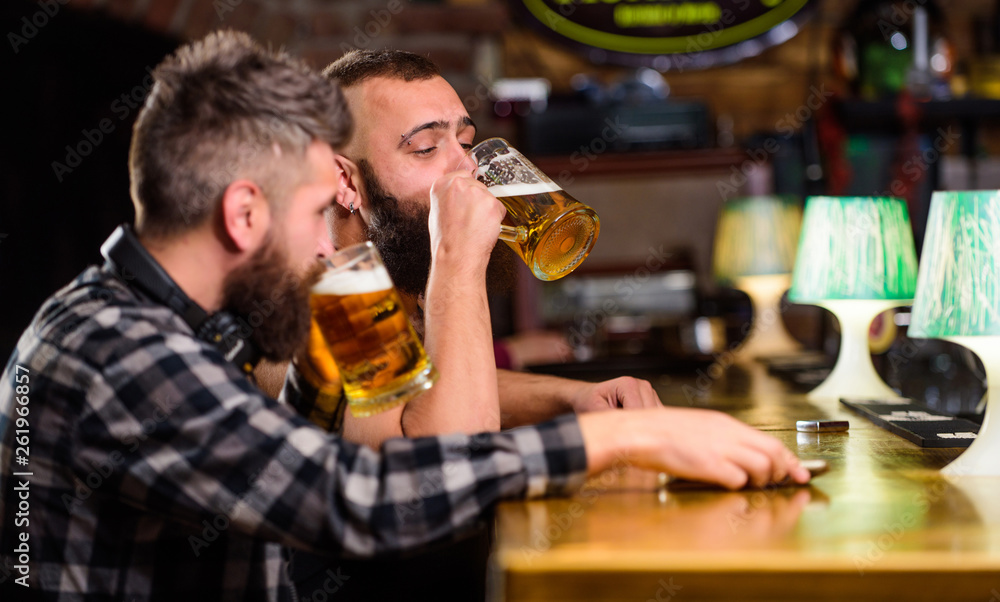 Hipster brutal man drinking beer with friend at bar counter. Men drunk ...