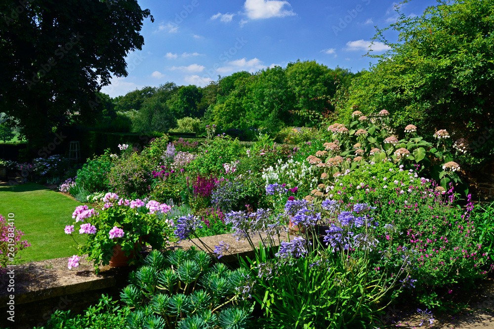 Garden view from terrace to colourful border and open countryside with ...