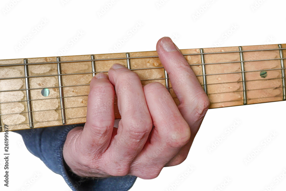 Guitarist’s hand fretting a barre A Major chord on a maple fretboard of ...