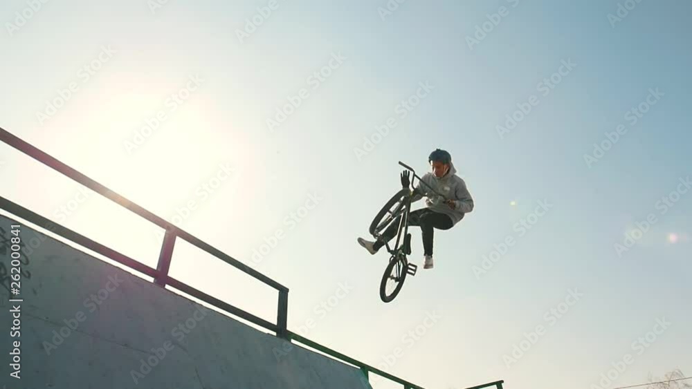 A bmx riders training their skills in the skatepark. Racing up ...