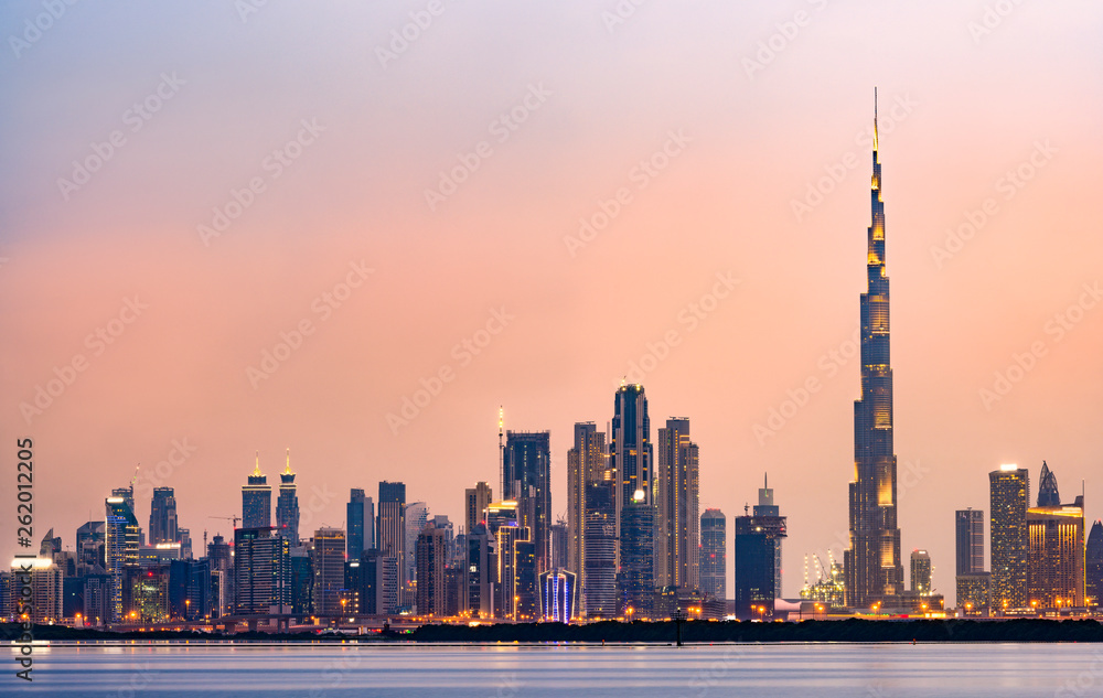 Stunning view of the illuminated Dubai skyline during sunset with the ...