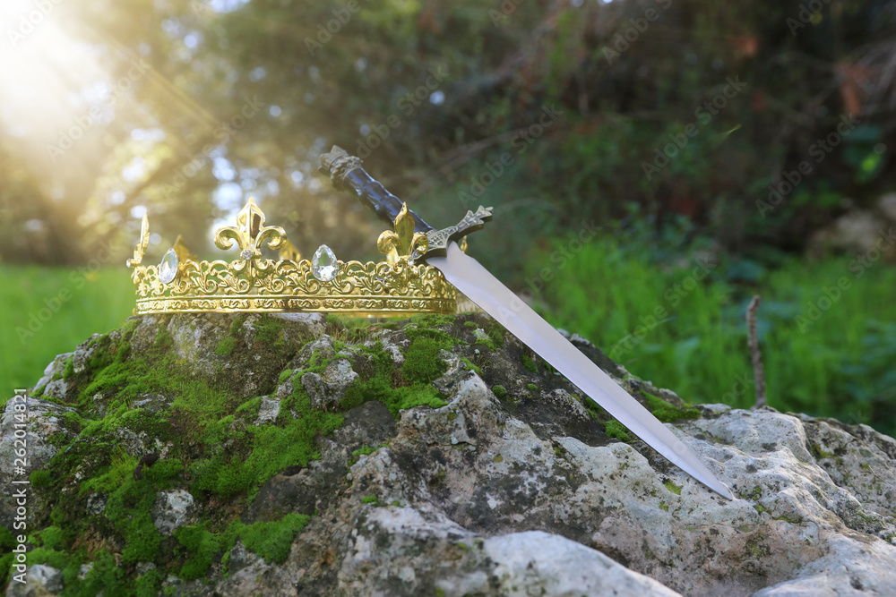 mysterious and magical photo of gold king crown and sword in the ...