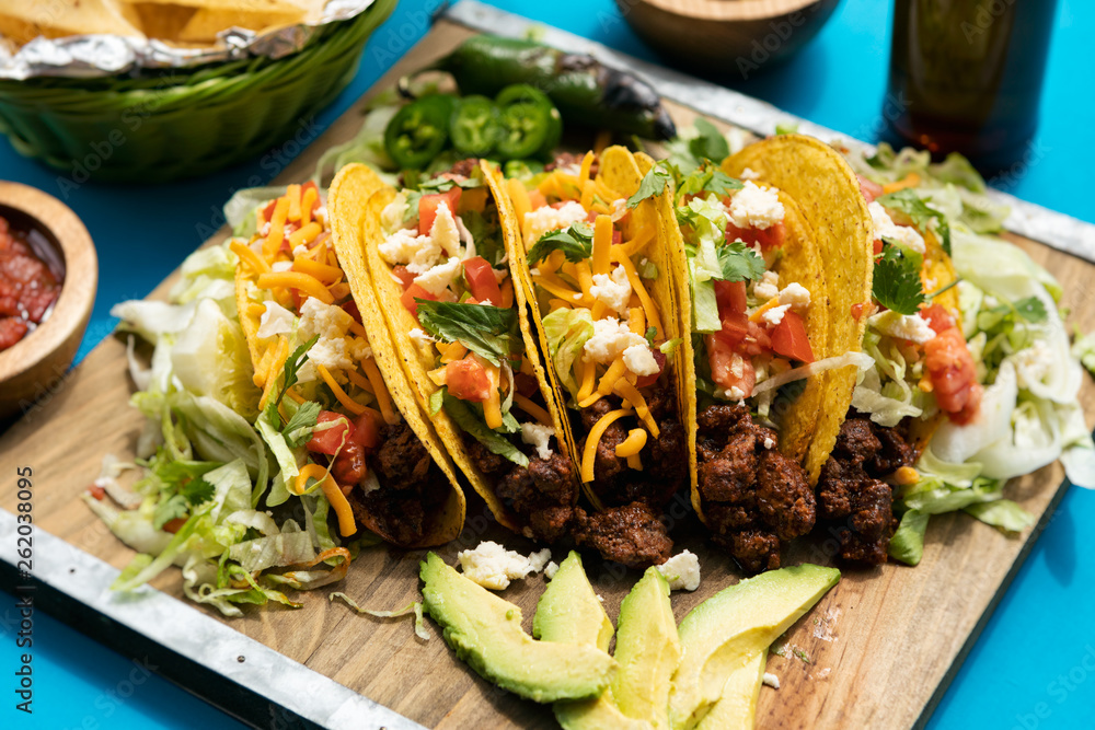 Cinco: Five Tacos On Board With Jalapenos And Avocado Stock Photo ...