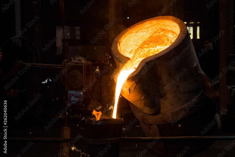 metal casting process with red high temperature fire in metal part ...