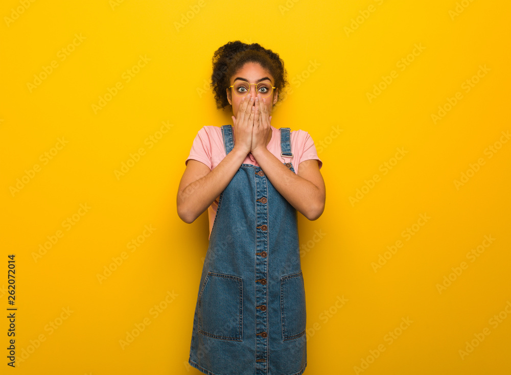 Young black african american girl with blue eyes very scared and afraid ...