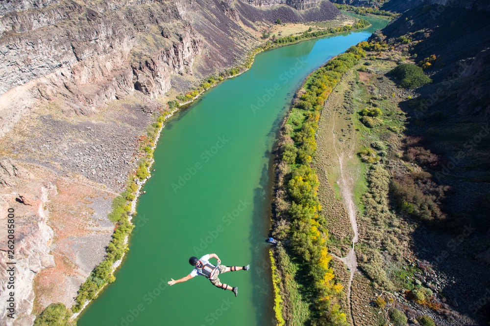 A BASE jumper leaps off the 486-foot Perrine Bridge in Twin Falls ...