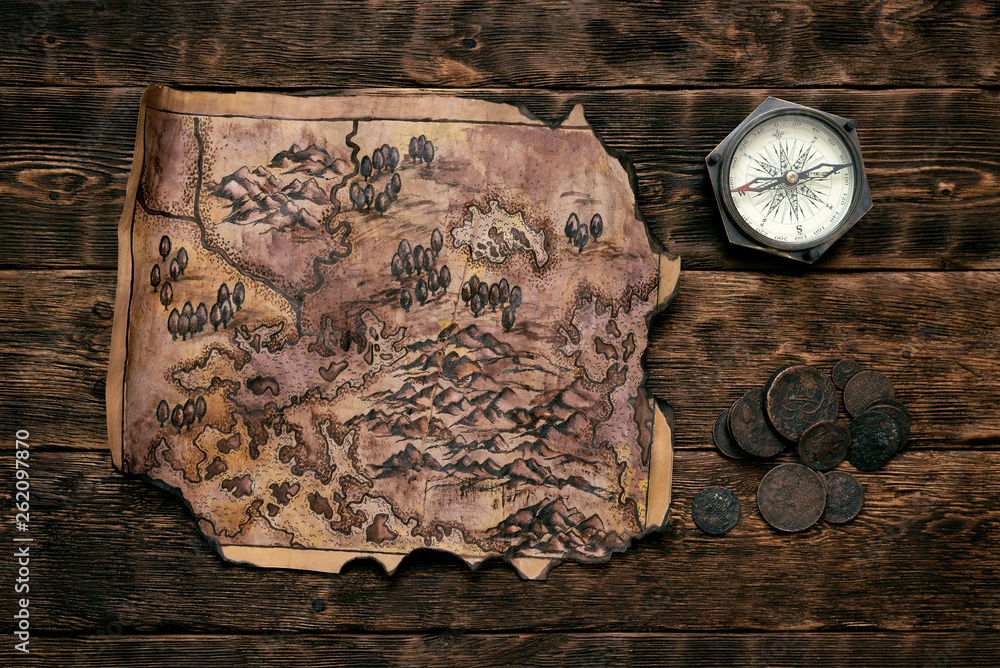 Old map and compass on a adventurer table background. Treasure hunt ...