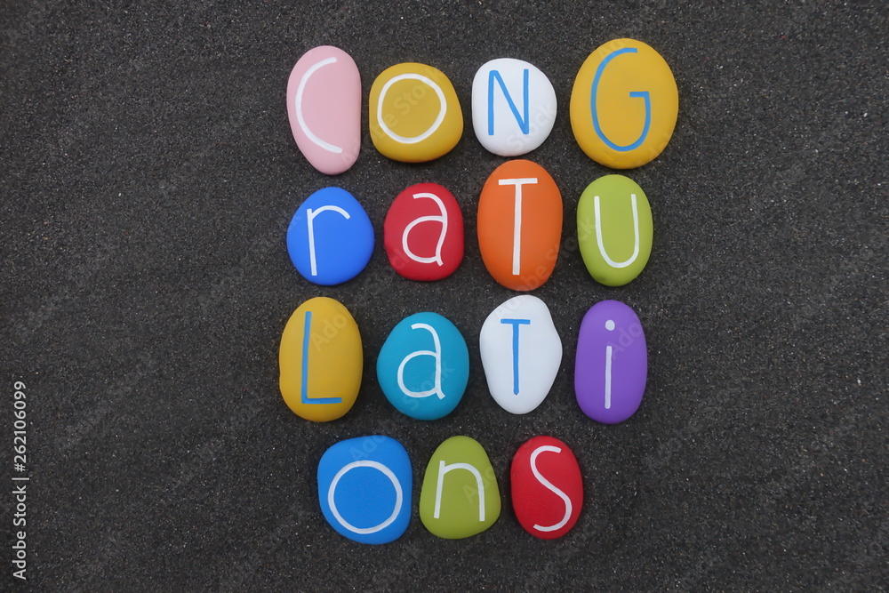 Congratulations text with a composition of multi colored sea stones ...