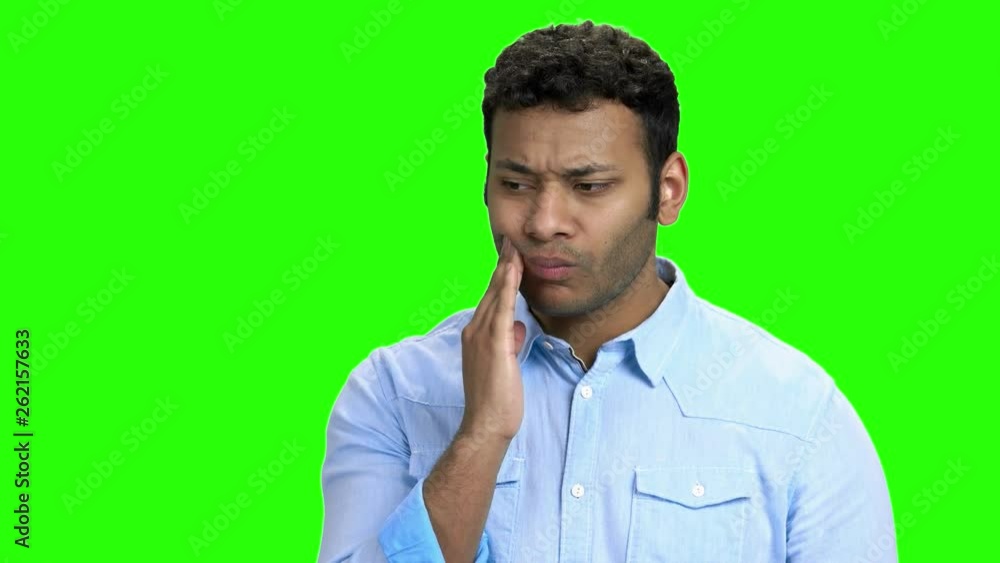 Indian guy having toothache on green screen. Man touching his cheek ...