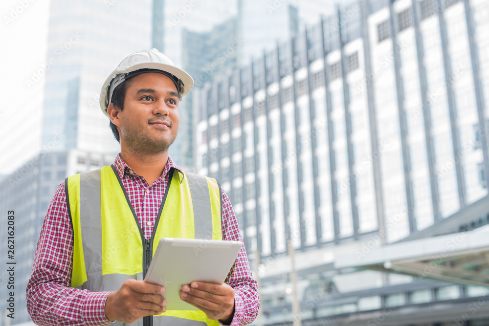 Young civil engineer and construction building background. Stock Photo ...