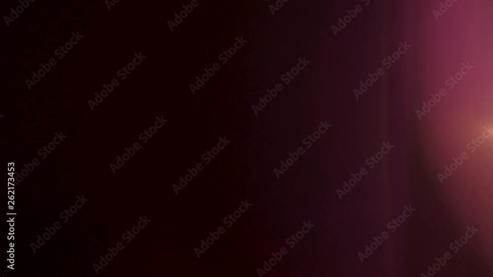 Optical lens flares moving on a dark background. Light rays caused by ...