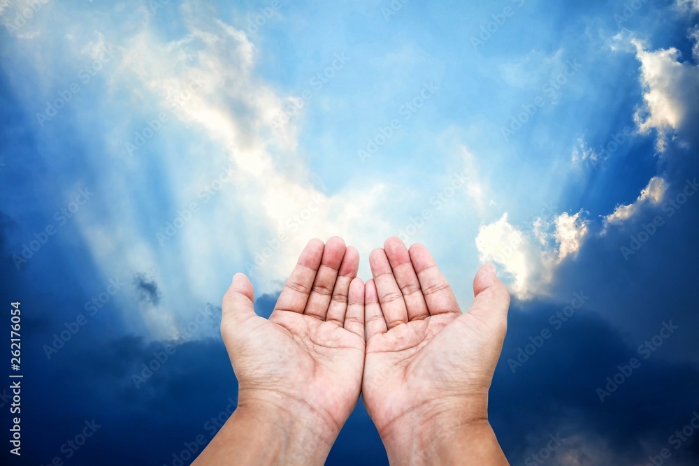 Praying Hands with Sunlight Beam behind white Clouds and Blue Sky ...