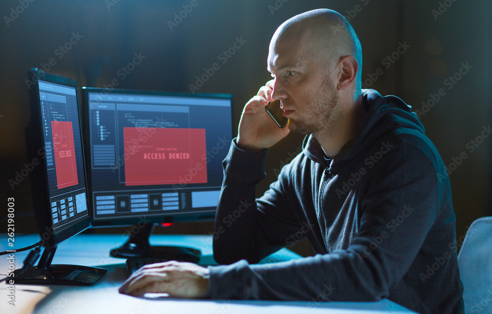 cybercrime, hacking and technology concept - male hacker with access denied messages on computer ...