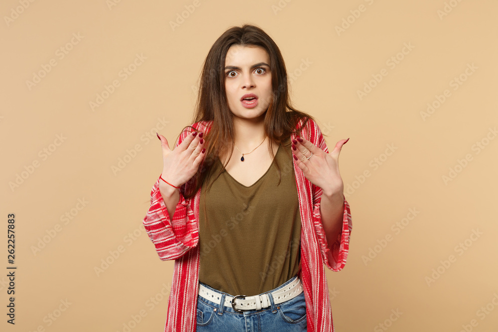 Portrait of shocked perplexed young woman in casual clothes looking ...