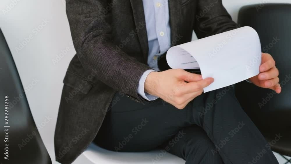 Business guy looking through documents. Cheking statistics report data ...