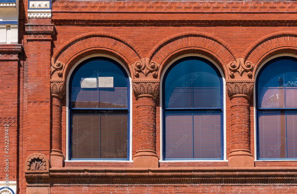 Architectural detail of arch window, red brick facade, vintage old ...