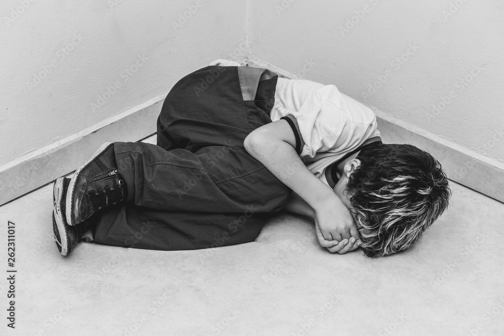 child in school uniform crying and hiding his face. Stock Photo | Adobe ...