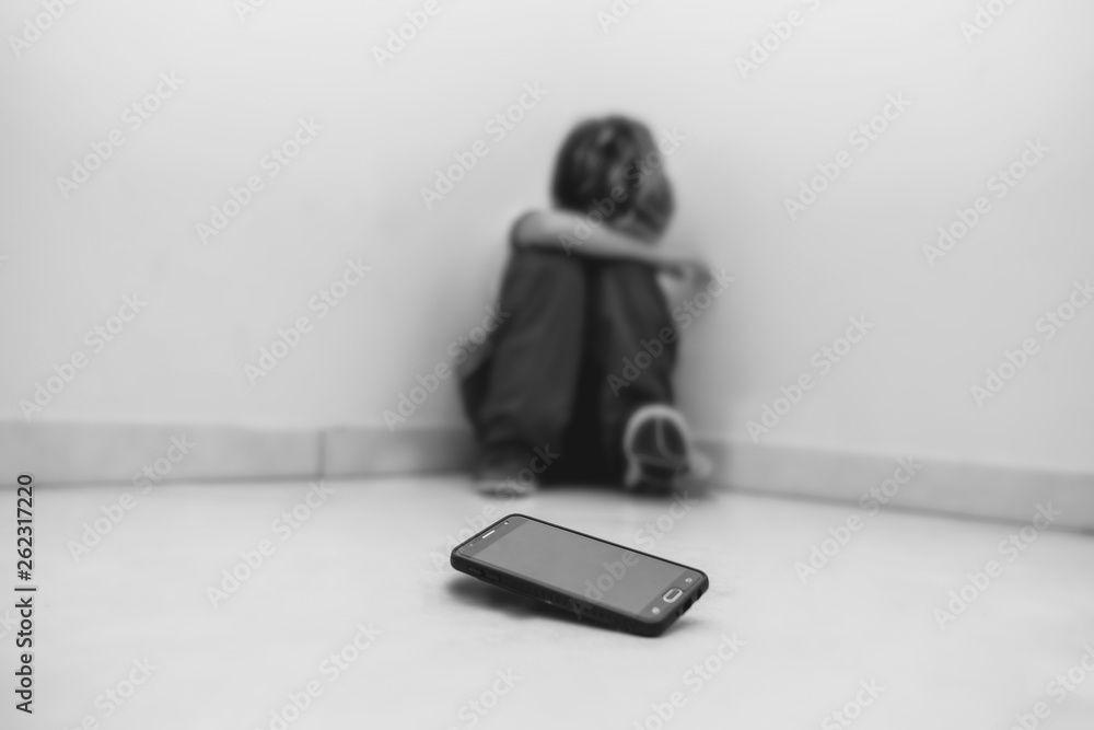 concept of cyber bulling. Child in school uniform crying in front of ...
