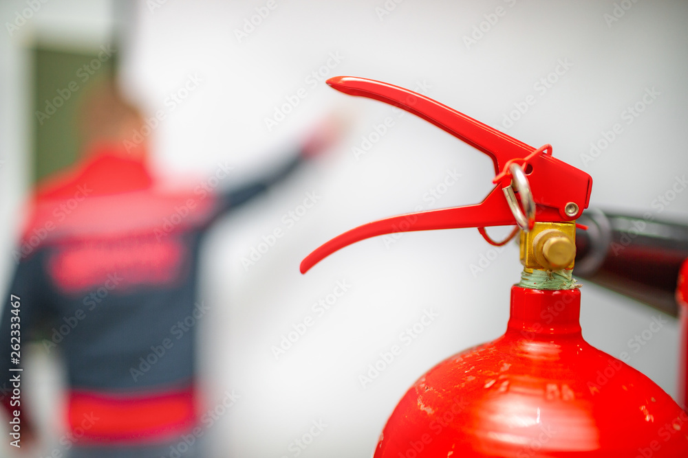 Uniformed fireman gives a lecture or instruction on fire safety. The ...