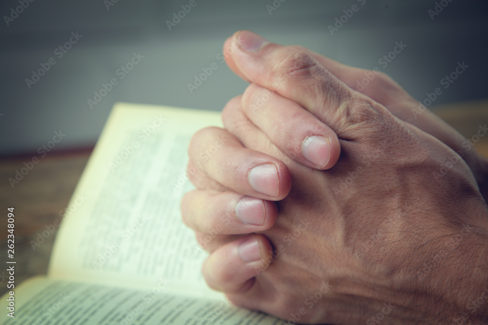 praying hands over a holy bible Stock Photo | Adobe Stock