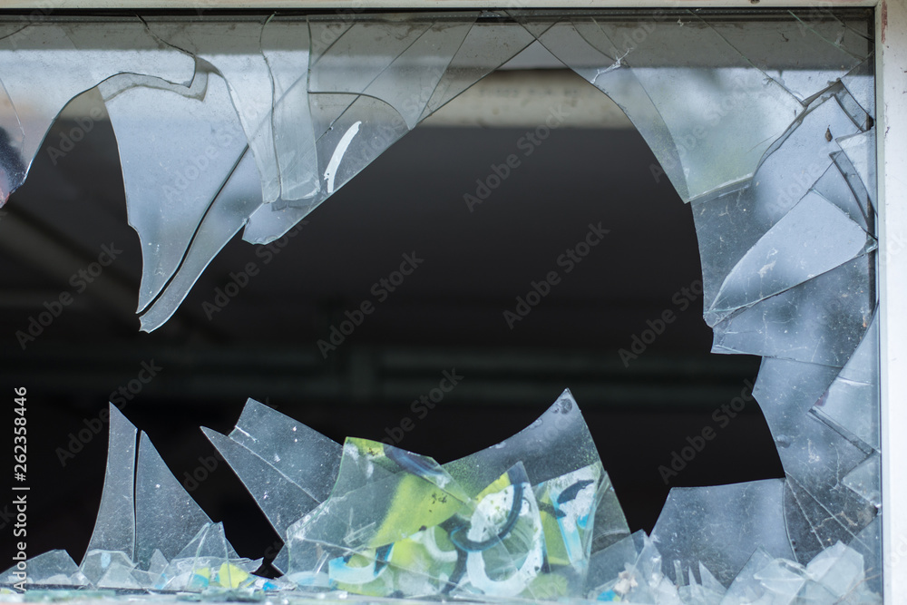 Broken window. Sharp protruding glass fragments. Stock Photo | Adobe Stock