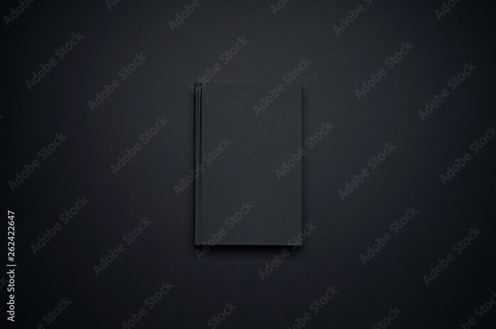Mockup of blank black book template isolated on black background for ...