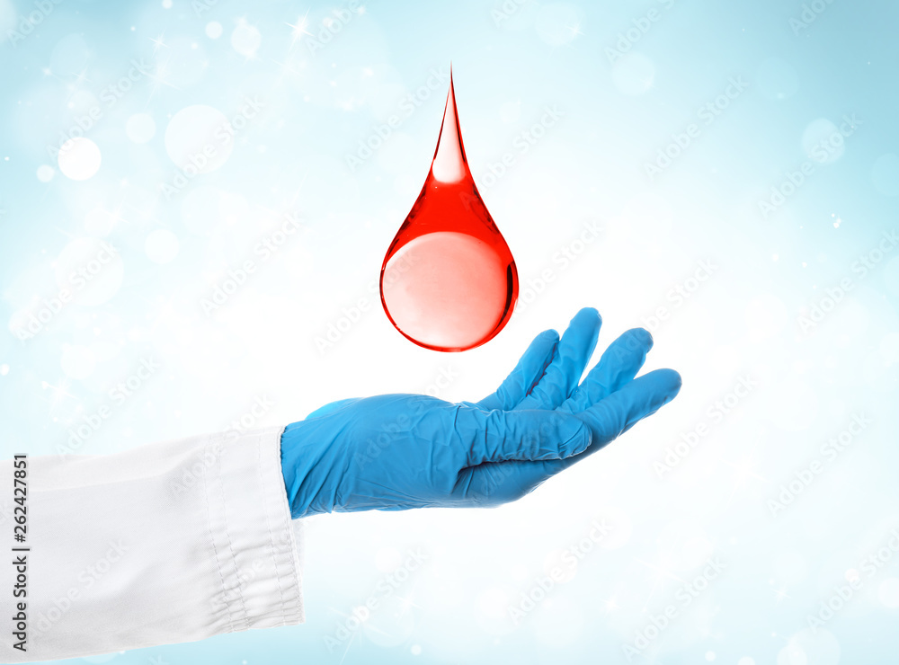 Doctor with drop of blood on light background Stock Photo | Adobe Stock